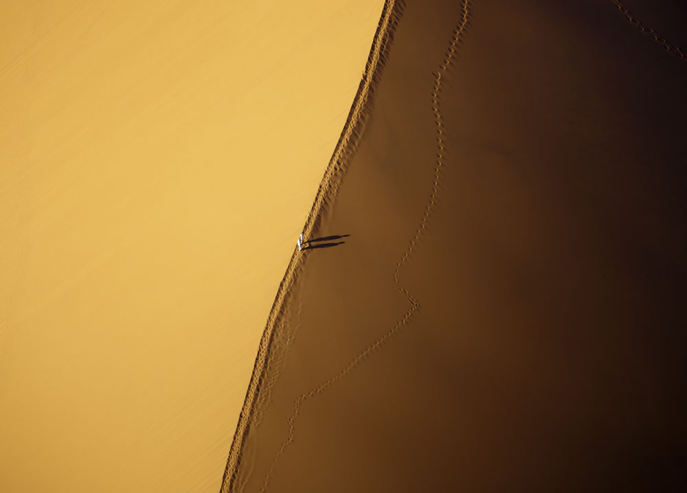Aerial view of hikers on Dune 45 in Sossusvlei, Namibia.
